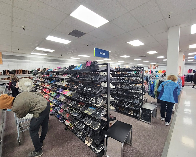 The shoe section stretches toward infinity, a footwear library where your next favorite pair waits patiently. Cinderella had one glass slipper; you could find twenty alternatives here.