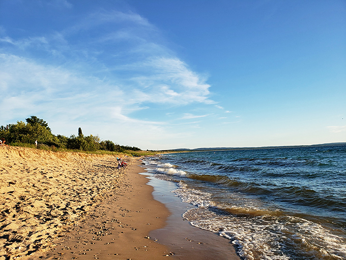 Mother Nature showing off her watercolor skills. Golden sand meets gentle waves under a sky so blue it seems almost manufactured.