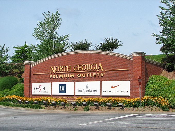 The entrance sign blooms with promise, surrounded by marigolds that seem to say "savings ahead!"