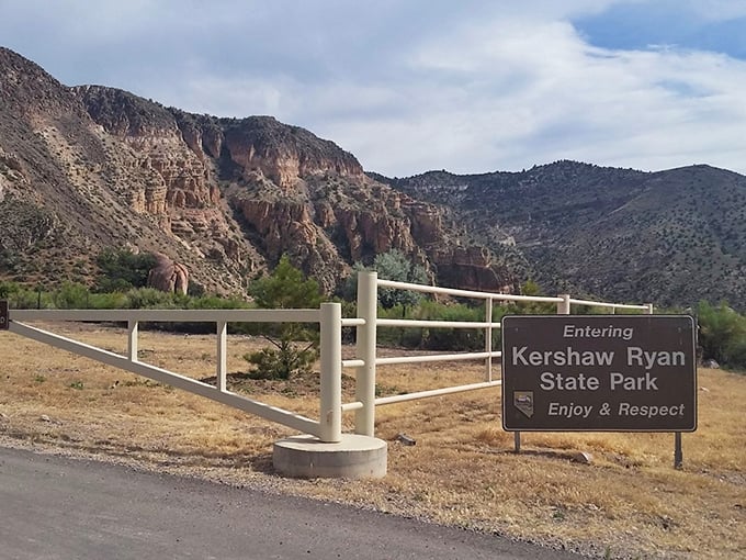 The entrance sign promises adventure ahead. Those mountains aren't just geological formations—they're nature's version of a "Welcome" banner.