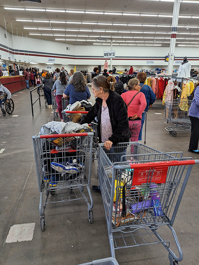 Bargain hunters in their natural habitat. The thrill of the hunt is palpable as shoppers navigate this sea of potential treasures.