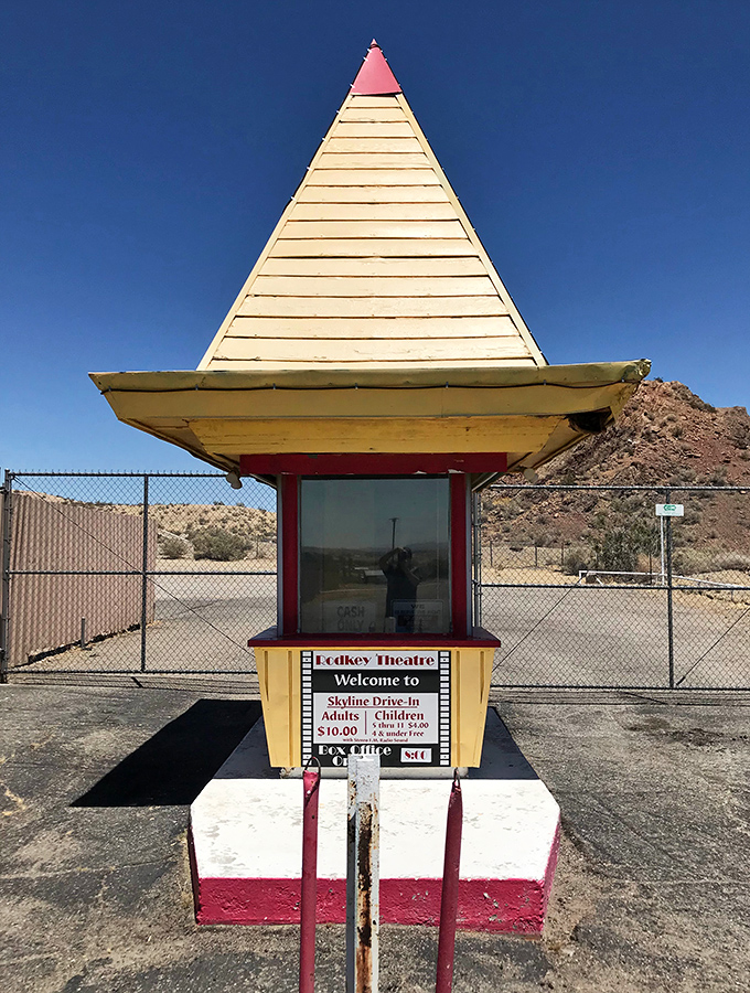 This charming ticket booth, with its distinctive pointed yellow roof, serves as a time portal to simpler entertainment eras.