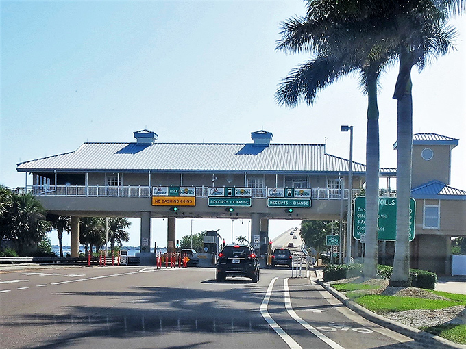 The toll booth stands as the final gatekeeper between mainland reality and island time. Six dollars buys you entry to a world where watches suddenly seem optional.