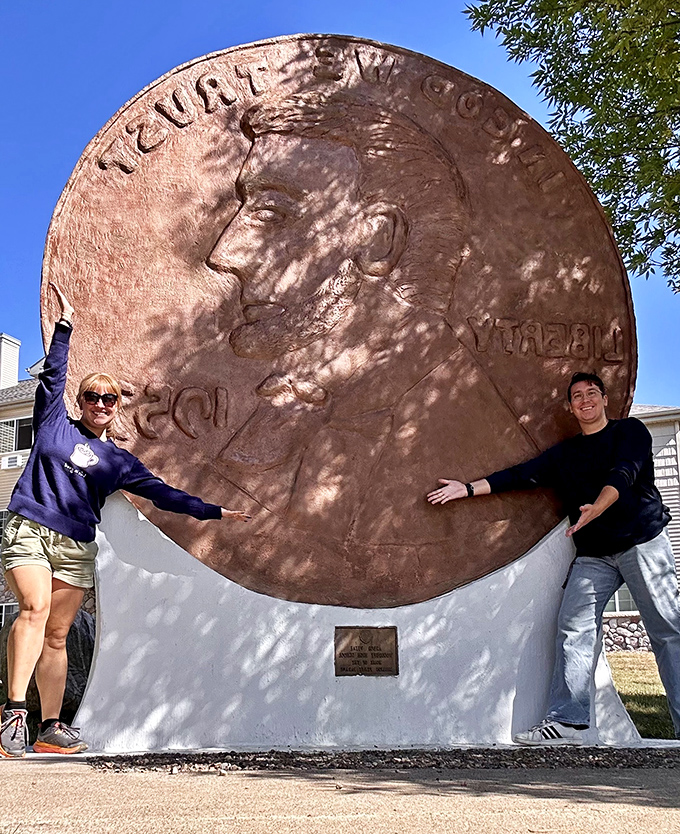 "I can hold it!" Visitors stretch their arms wide, attempting the impossible task of embracing America's most valuable one cent.
