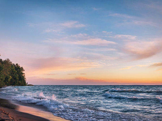 Sunset transforms Lake Michigan into liquid gold, proving that the best light shows don't require tickets—just perfect timing.