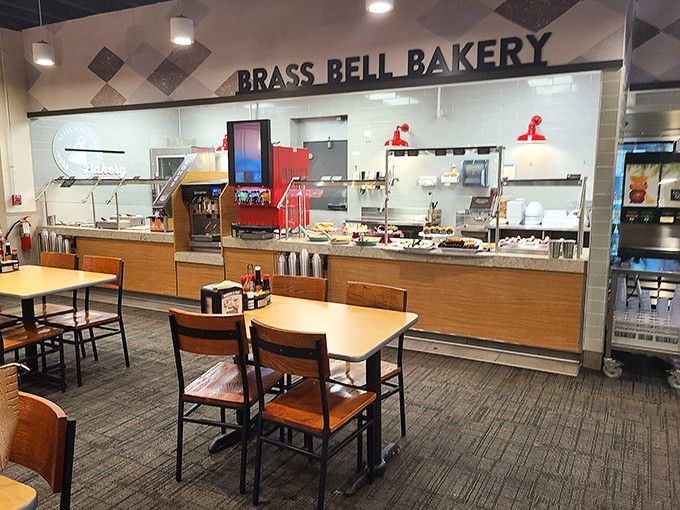 The Brass Bell Bakery station gleams under those lights like a dessert lover's version of heaven, organized and ready for your inevitable sugar rush.