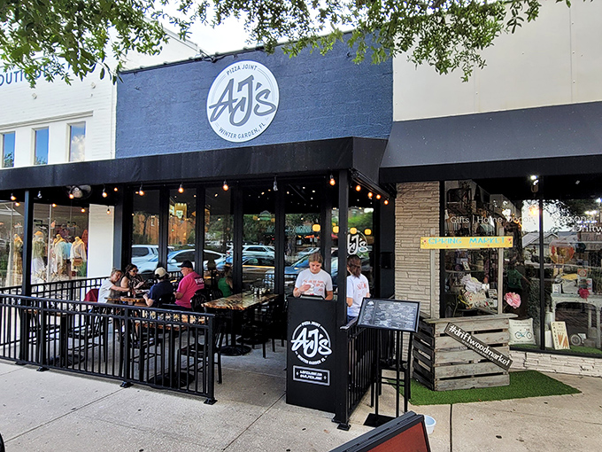 Patio perfection! AJ's outdoor seating area is where Winter Garden locals gather to debate important matters like "Is pizza better than birthday cake?" (Spoiler alert: it's a tie).