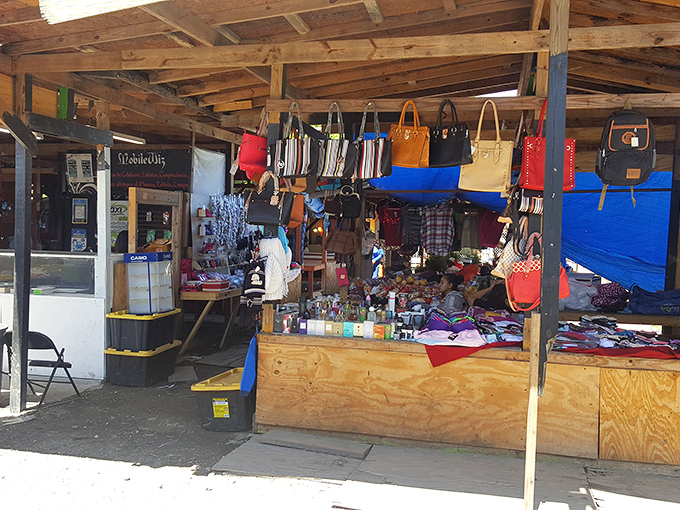 Handbags dangle like party decorations while wooden tables overflow with treasures waiting for new homes.