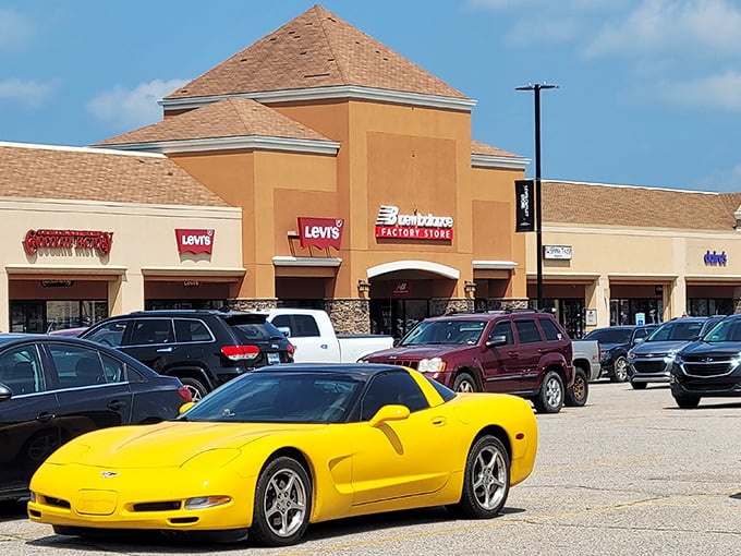 That yellow Corvette knows where the real treasures are - parked right at outlet heaven.