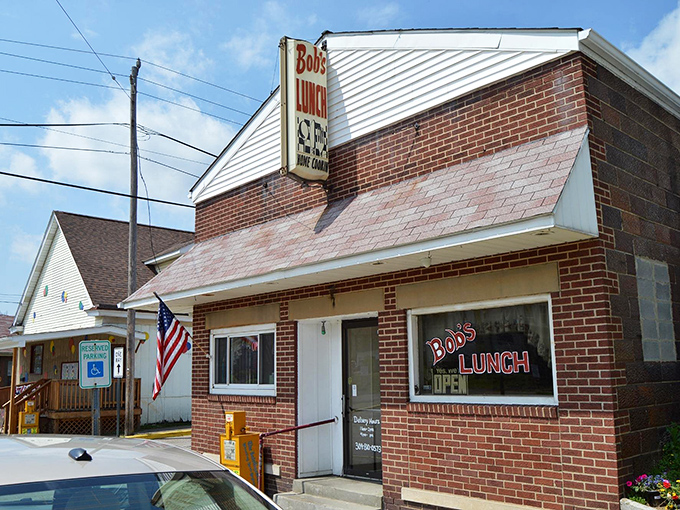 Bob's Lunch stands proudly with its brick facade and American flag. The kind of place where the coffee's always hot and the gossip's always fresh.