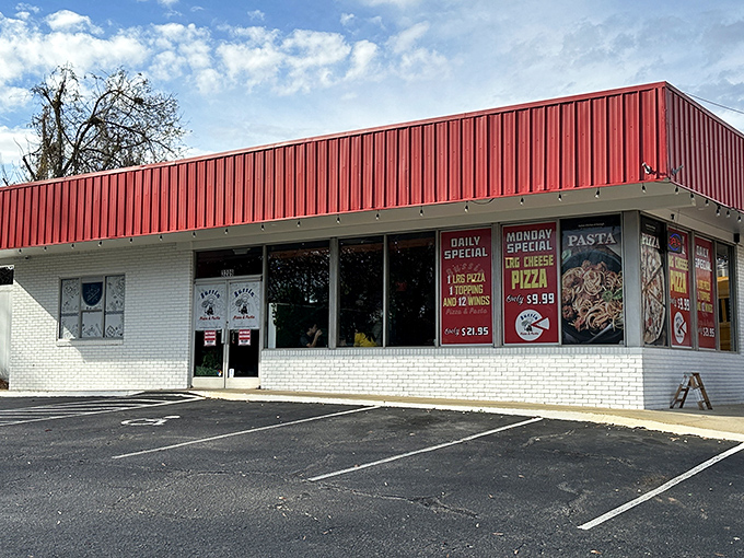 Bussin Pizza's bright red roof stands out like a beacon for hungry pizza lovers. No frills, just fantastic flavor.