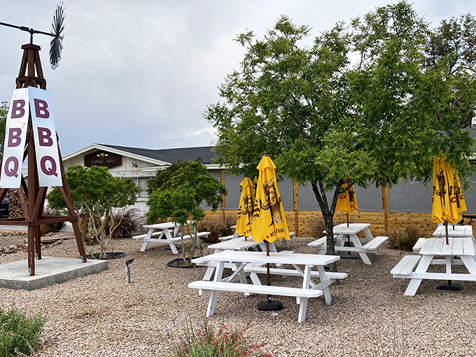 Desert dining at its finest - where picnic tables and yellow umbrellas create BBQ paradise.