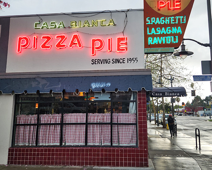 Casa Bianca's neon glow promises the kind of pizza that built Los Angeles neighborhoods, one slice at a time. 