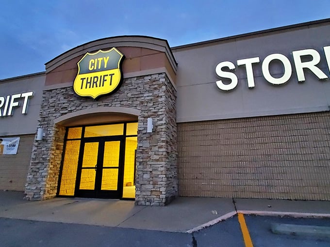 City Thrift's stone-clad entrance glows like a beacon at dusk. That shield-shaped sign hints at the noble quest of finding bargains within!