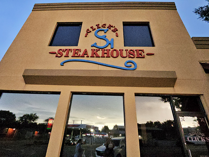 Click's Steakhouse stands proudly in Pawnee, its bright yellow facade like a beacon for beef lovers.
