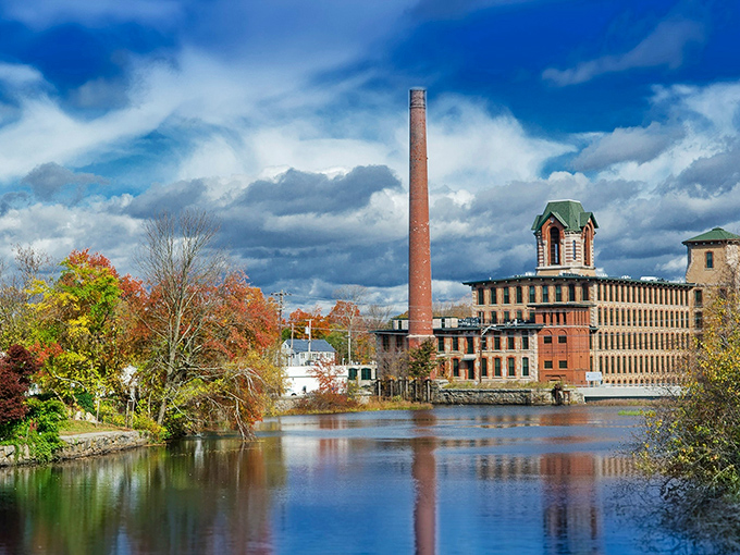 Industrial elegance meets nature's canvas in Coventry. That smokestack has stories taller than Paul Bunyan's tales, reflected perfectly in nature's mirror.