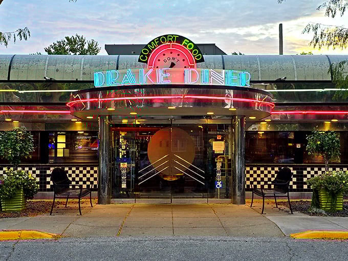 Drake Diner's gleaming silver exterior shines like a time machine to the 1950s. The neon "Comfort Food" sign tells you everything you need to know.