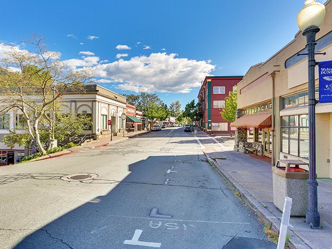 Sloping into savings! Dunsmuir's colorful storefronts create a retirement postcard where your Social Security check stretches like the blue sky above.