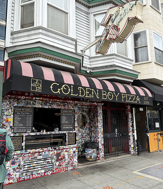 Golden Boy's sticker-covered facade is like a pizza passport. Every colorful inch tells stories of satisfied customers.