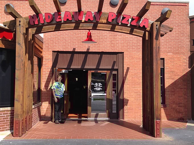 Hideaway's wooden entrance arch feels like stepping into pizza paradise. That red brick building has seen generations of happy diners come through those doors.