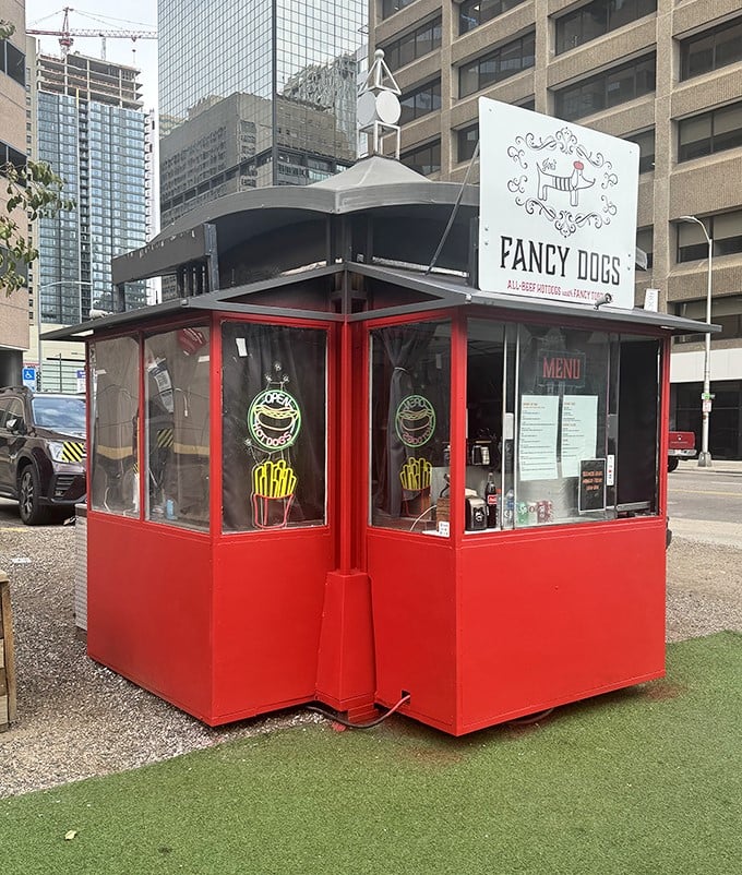 This little red hot dog kiosk stands defiant among Denver's skyscrapers, like David facing a forest of corporate Goliaths.