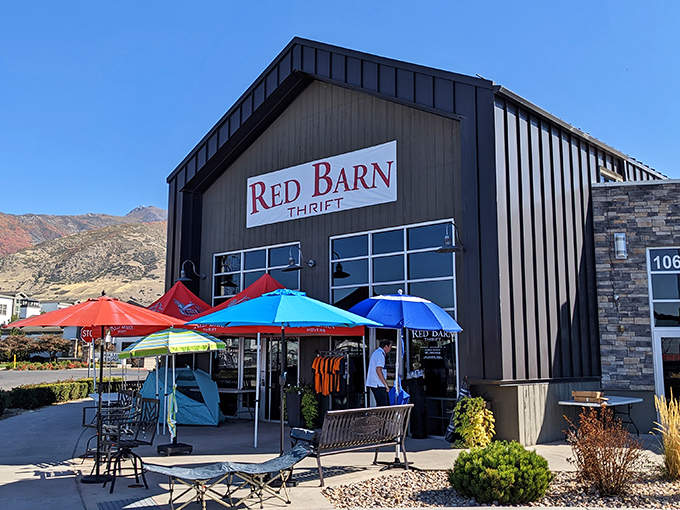 Red Barn Thrift's colorful umbrella oasis makes bargain hunting feel like a festive outdoor market against Utah's mountains.