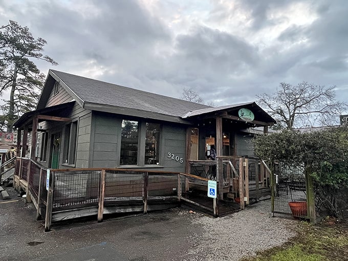 This green cottage looks like it escaped from a storybook and decided to serve coffee.