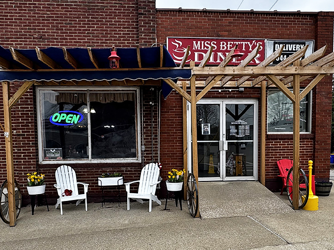 White chairs on a brick porch whisper promises of homestyle cooking and unhurried mornings ahead.