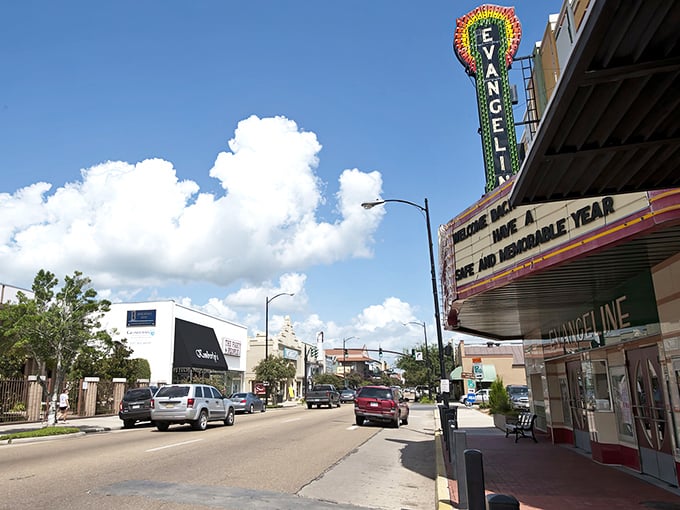 The Evangeline Theatre's neon sign glows like a beacon, promising entertainment in true small-town Louisiana style.
