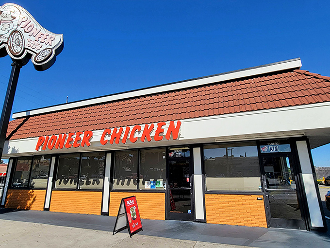 Pioneer Chicken's iconic orange-red signage &ndash; a beacon of hope for fried chicken lovers since the disco era.