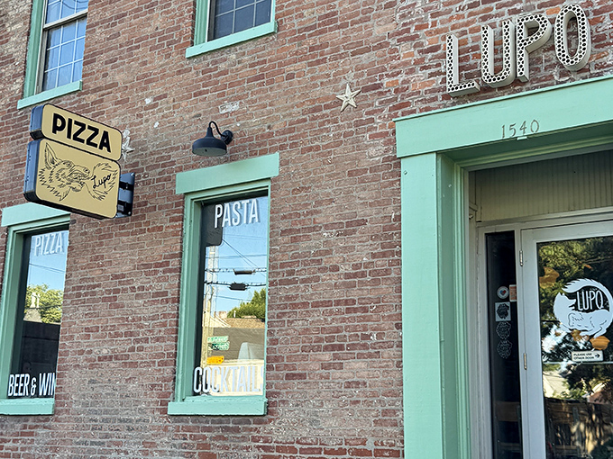 Pizza Lupo's charming brick exterior with mint-green accents looks like it was plucked from a storybook about perfect neighborhood eateries.