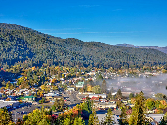 Quincy's autumn tapestry unfolds beneath misty mountain guardians, where fall's fiery palette transforms this Sierra hideaway into nature's own Technicolor dreamcoat.