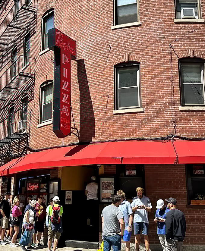Regina's iconic vertical sign has guided pizza pilgrims through Boston's North End for generations. The line? Always worth it.