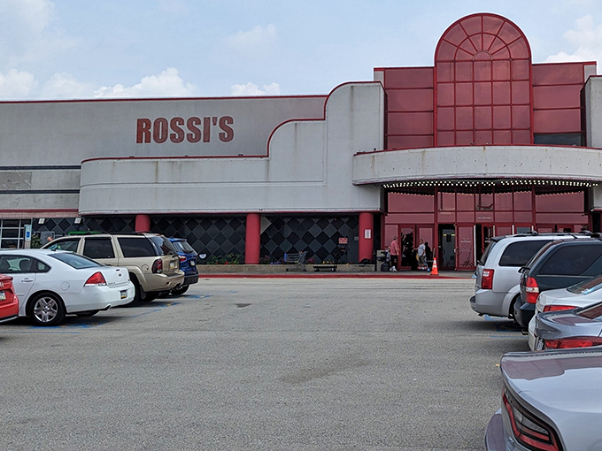 Rossi's Flea Market's distinctive red entrance beckons bargain hunters inside. The architecture says "1980s shopping mall meets treasure cave" in the best possible way.