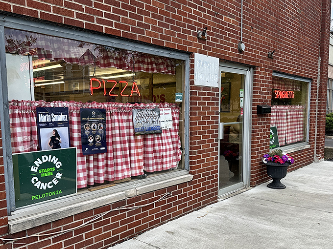Red checkered curtains whisper promises of authentic Italian comfort food made with love.