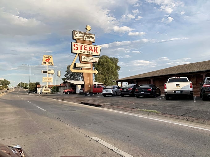 The Silver Saddle's vintage sign stands tall against the Arizona sky. When a restaurant advertises "STEAK" this boldly, you know they mean business.
