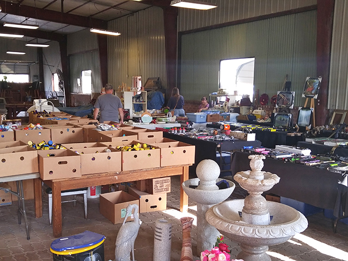 Organized chaos at its finest! Boxes of potential treasures surround a decorative fountain, creating a bargain hunter's paradise.