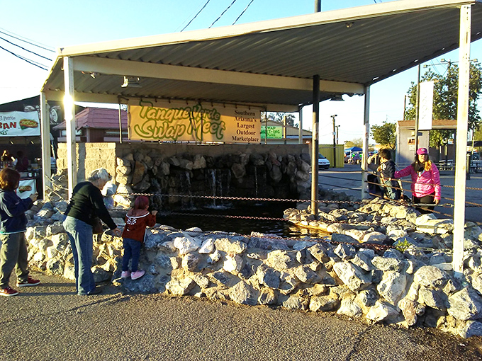 A desert oasis of deals! Tanque Verde's fountain area offers a cool respite for young treasure hunters between finds.