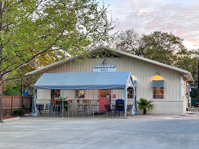The Devine Cinnamon Roll Deli's charming cottage-like building promises comfort food that hugs your soul.