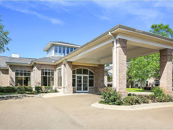 The Waterford's elegant stone entrance says "welcome home" with the confidence of a place that knows how to treat its residents right.