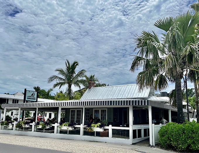 The Waterfront Restaurant's classic white facade whispers "come as you are" to every hungry beachgoer.