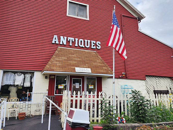 That red barn exterior with patriotic flair makes antiquing feel like a wholesome American adventure story.