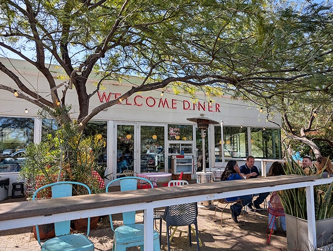 Welcome Diner's outdoor seating beckons under desert trees – where breakfast meets fresh air in a setting straight out of a postcard.