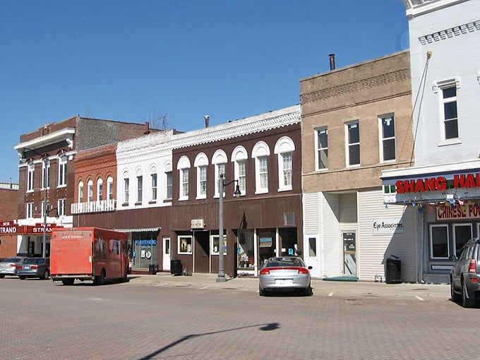 Brick facades stand proud like sentries guarding decades of shared memories and morning coffee traditions.