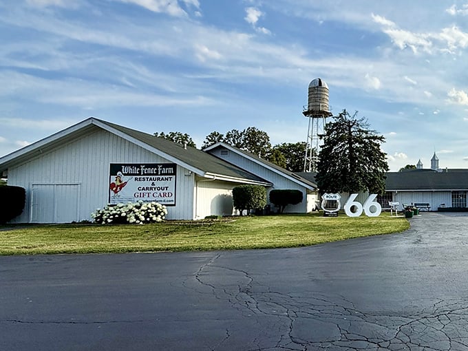 White Fence Farm stands like a chicken paradise oasis. That water tower isn't holding water &ndash; it's storing decades of delicious memories.