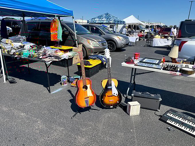 Rock star dreams for garage sale prices! These lonely guitars wait patiently on asphalt for their next gig while keyboard and clothing treasures bask in the sunshine.