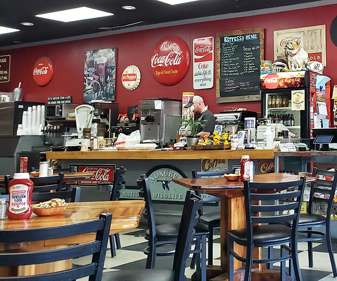 Red walls adorned with vintage Coca-Cola signs create the perfect backdrop for morning conversations and coffee refills.