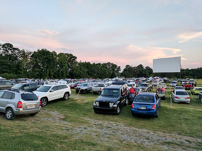 The screen stands sentinel against the fading light. 411 Twin Drive-In's simple magic awaits as engines fall silent.