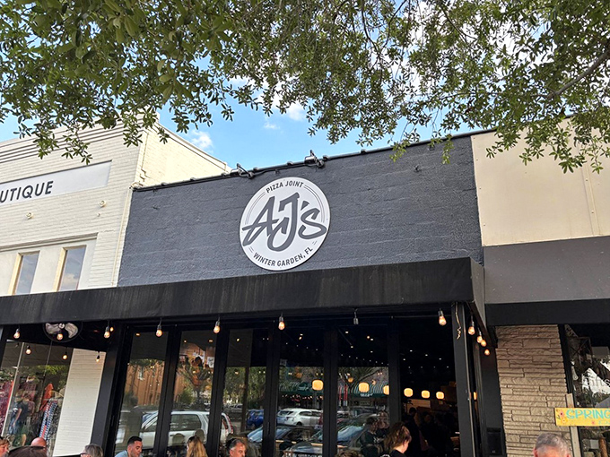 That sleek blue awning is like a beacon for pizza pilgrims. AJ's has mastered the art of making a storefront look as inviting as your favorite aunt's kitchen.