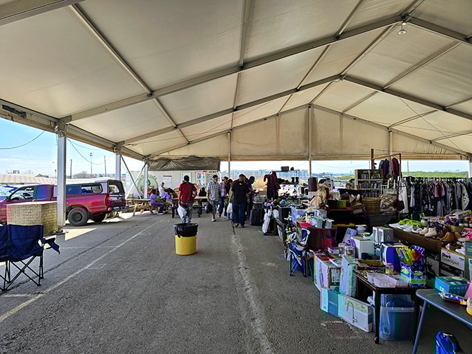 Under the big white tent, weekend warriors hunt for bargains while vendors display their wares in neat rows.